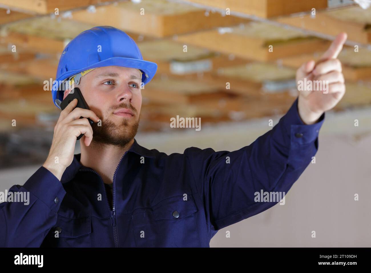 a builder pointing with a finger Stock Photo - Alamy