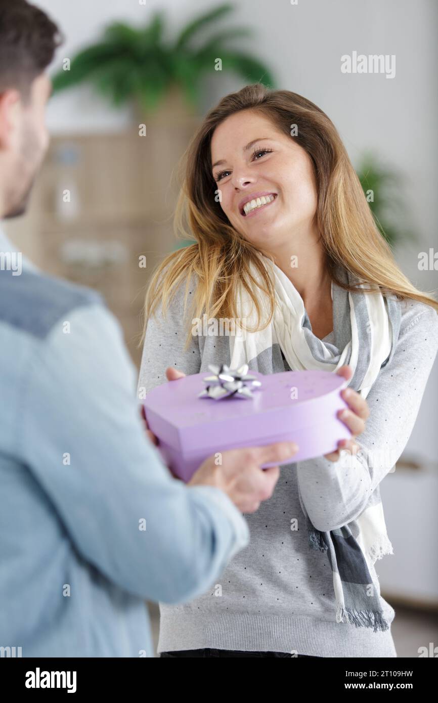 man giving gift in heart shaped box Stock Photo - Alamy