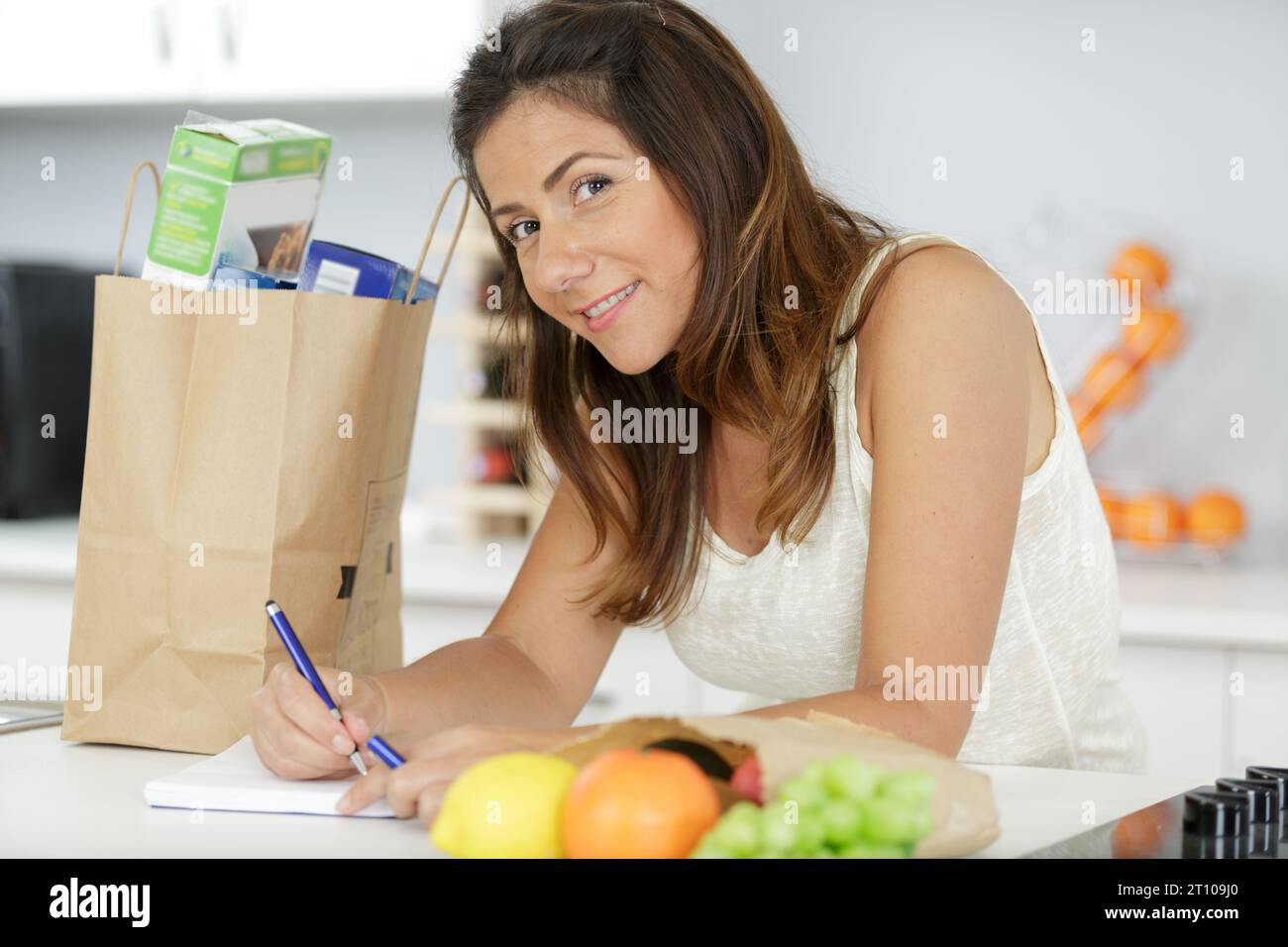 a woman is checking shopping list Stock Photo - Alamy
