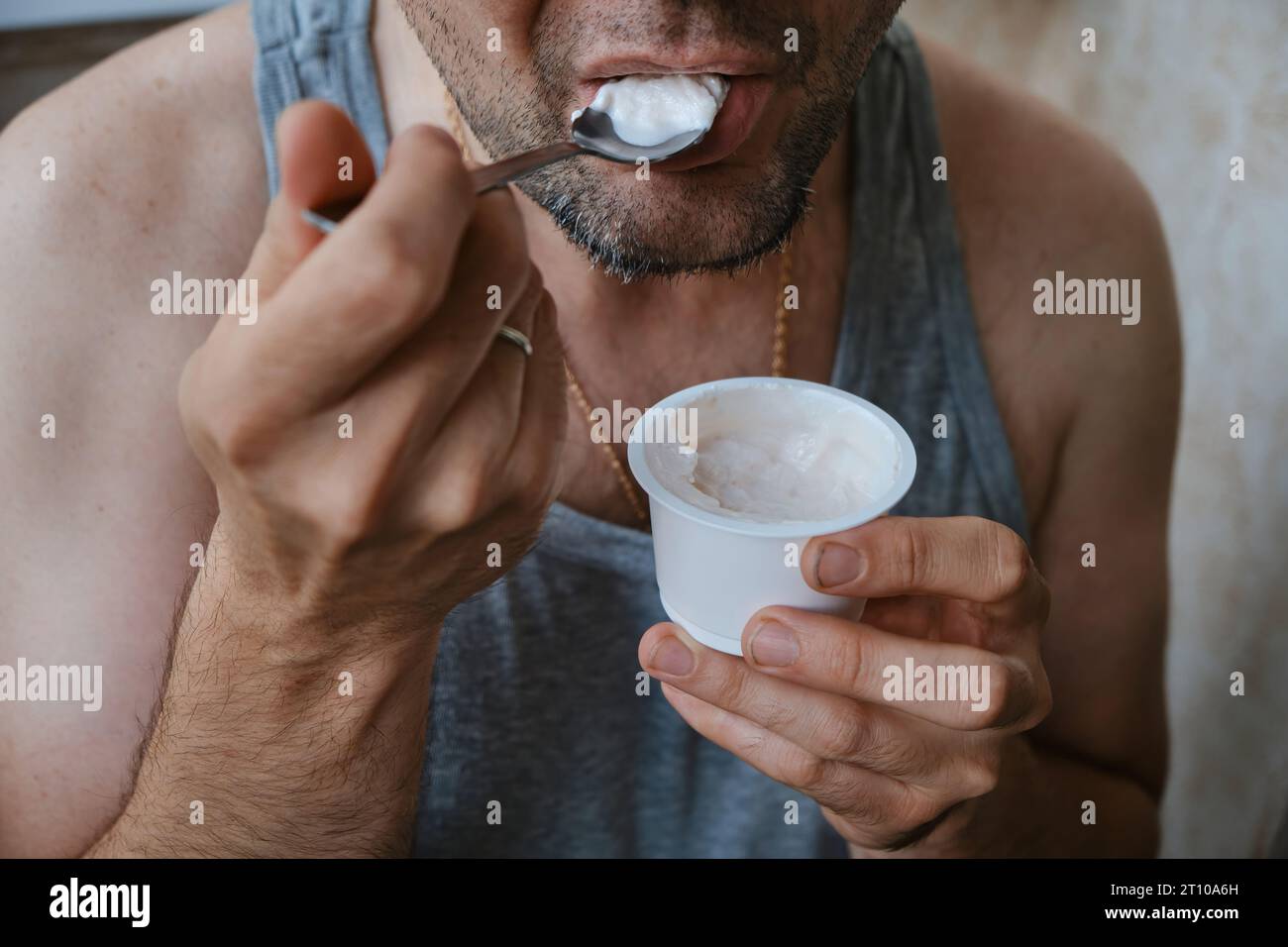 Healthy breakfast variety. Yogurt with fruit and seeds. Man eating ...