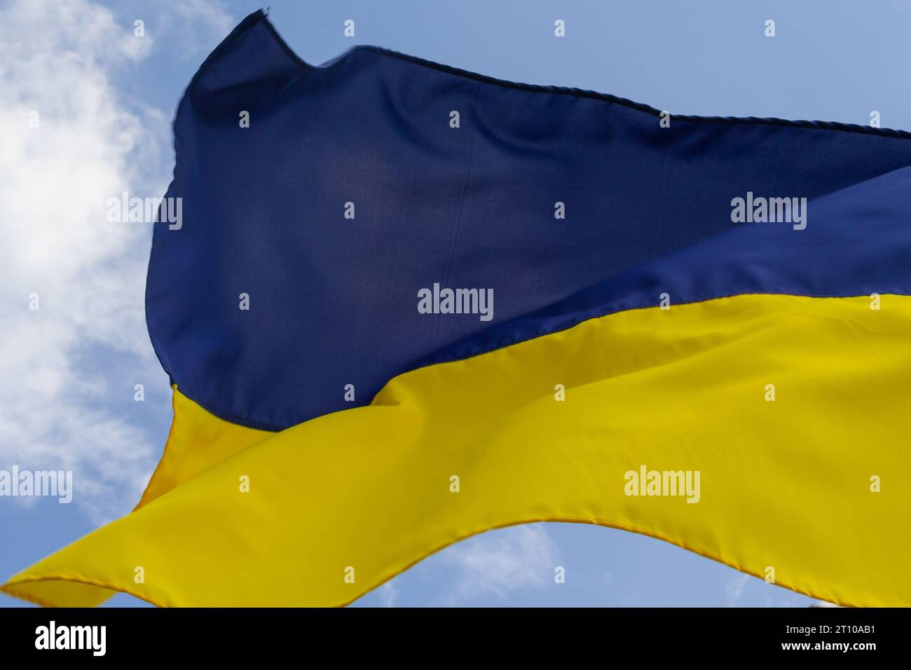 Ukrainian flag in the wind on blue sky background. Large national ...
