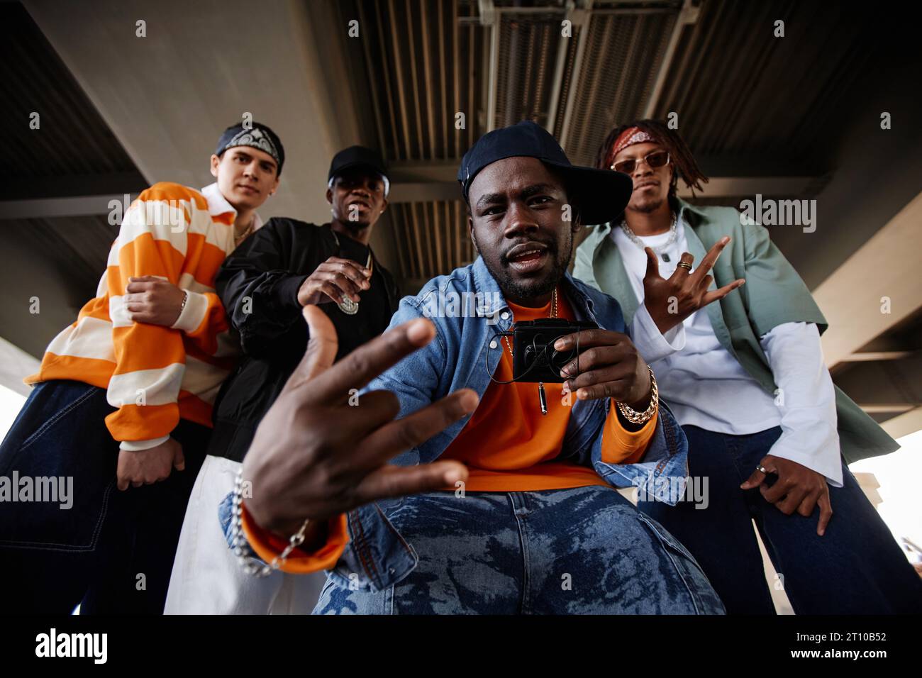 One of four young intercultural members of popular boy band dancing hip ...