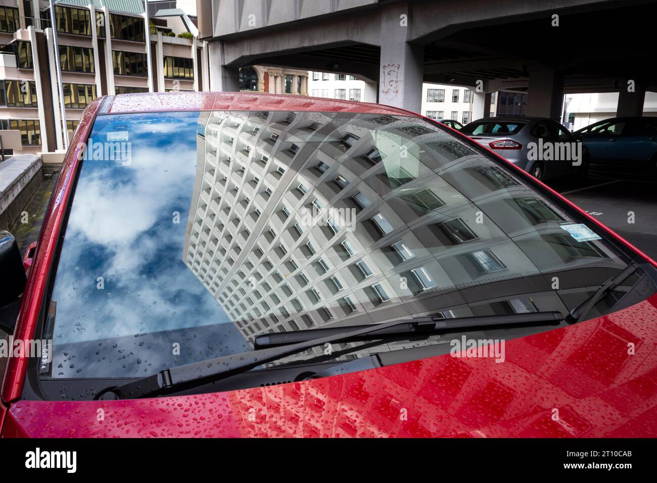Office building reflected in car windscreen, Wellington, North Island ...