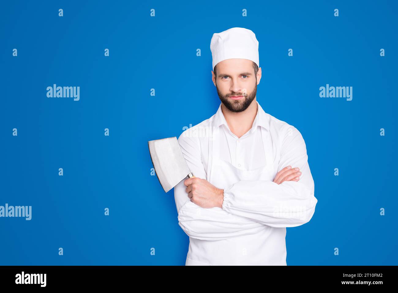 Portrait of handsome attractive butcher in beret having his arms ...