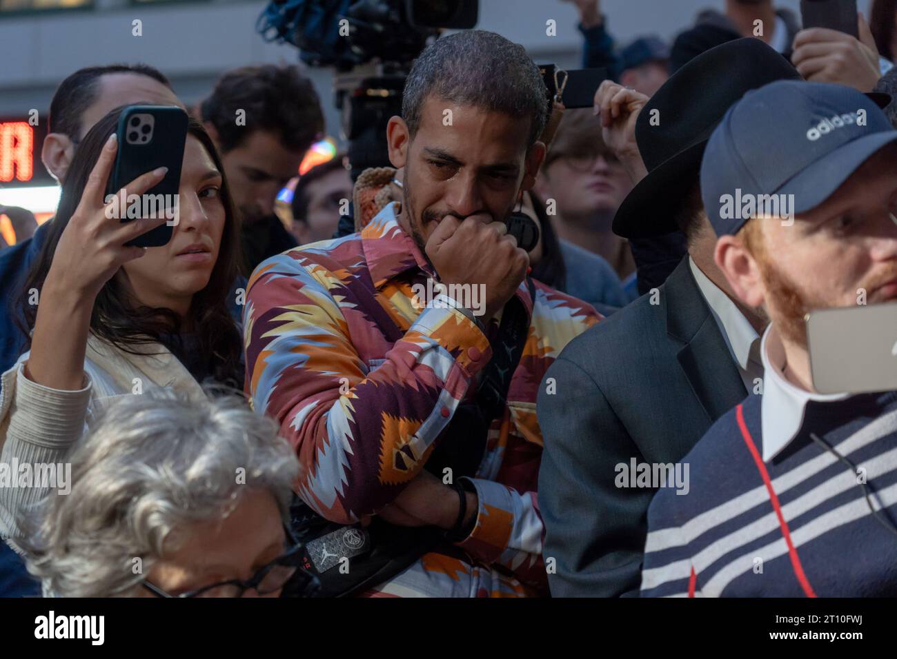 A man gets emotional and sheds tears at a Candlelight Vigil for Victims ...