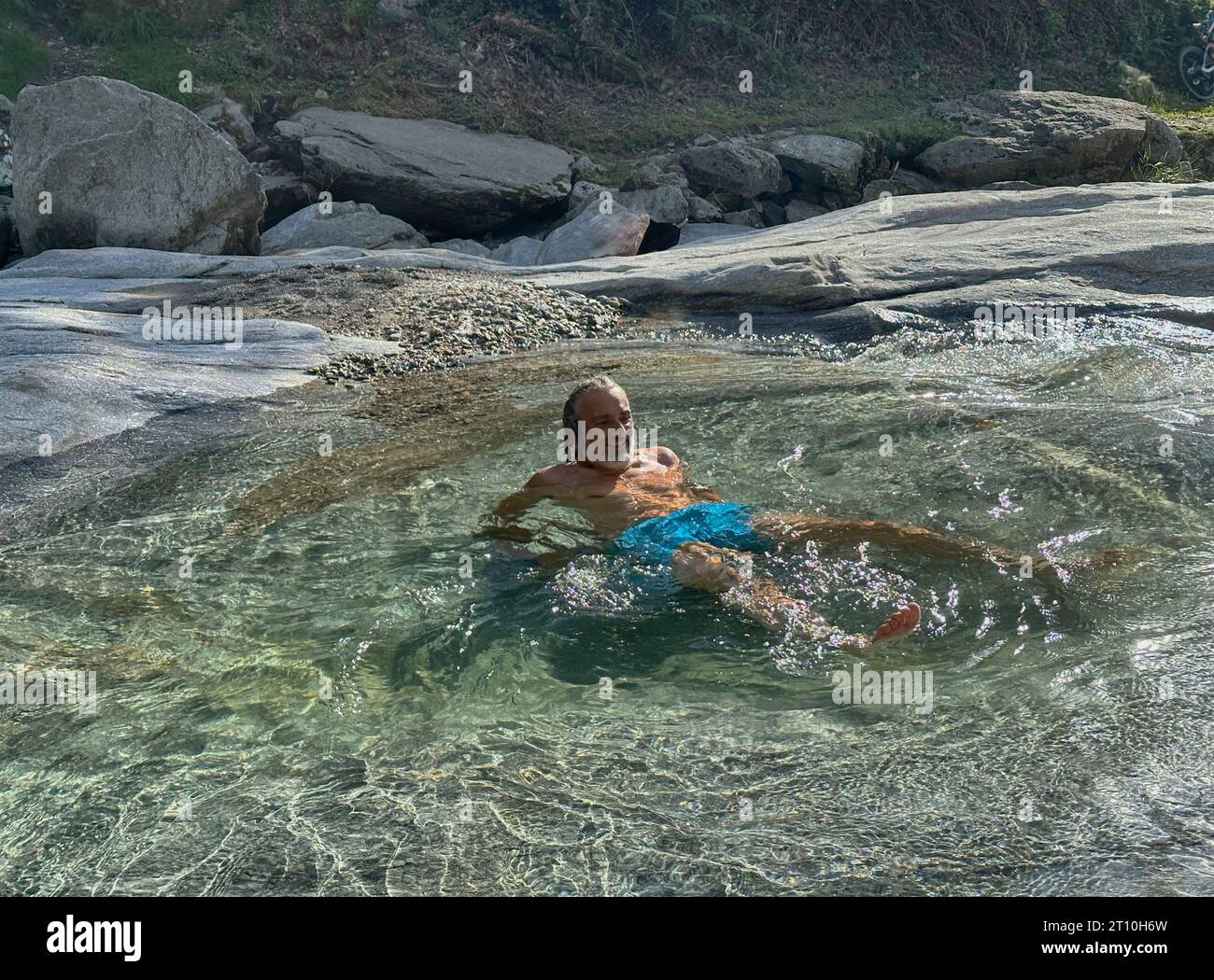 Man bathing at the Santa Petronilla waterfall , Biasca, Switzerland ...