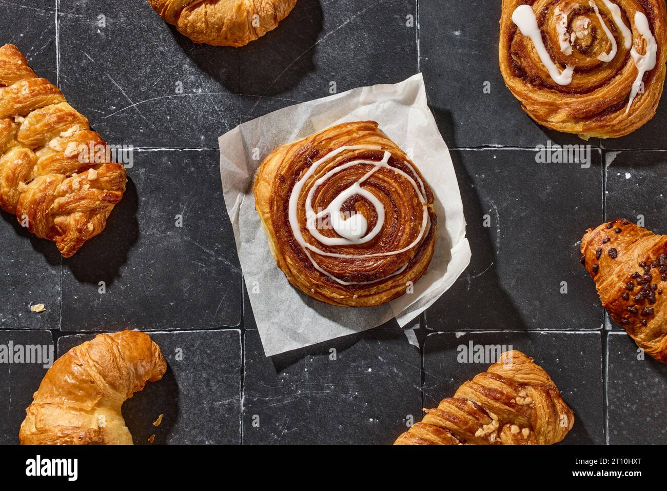 assorted pastries on dark grey old tiles background, top view Stock ...