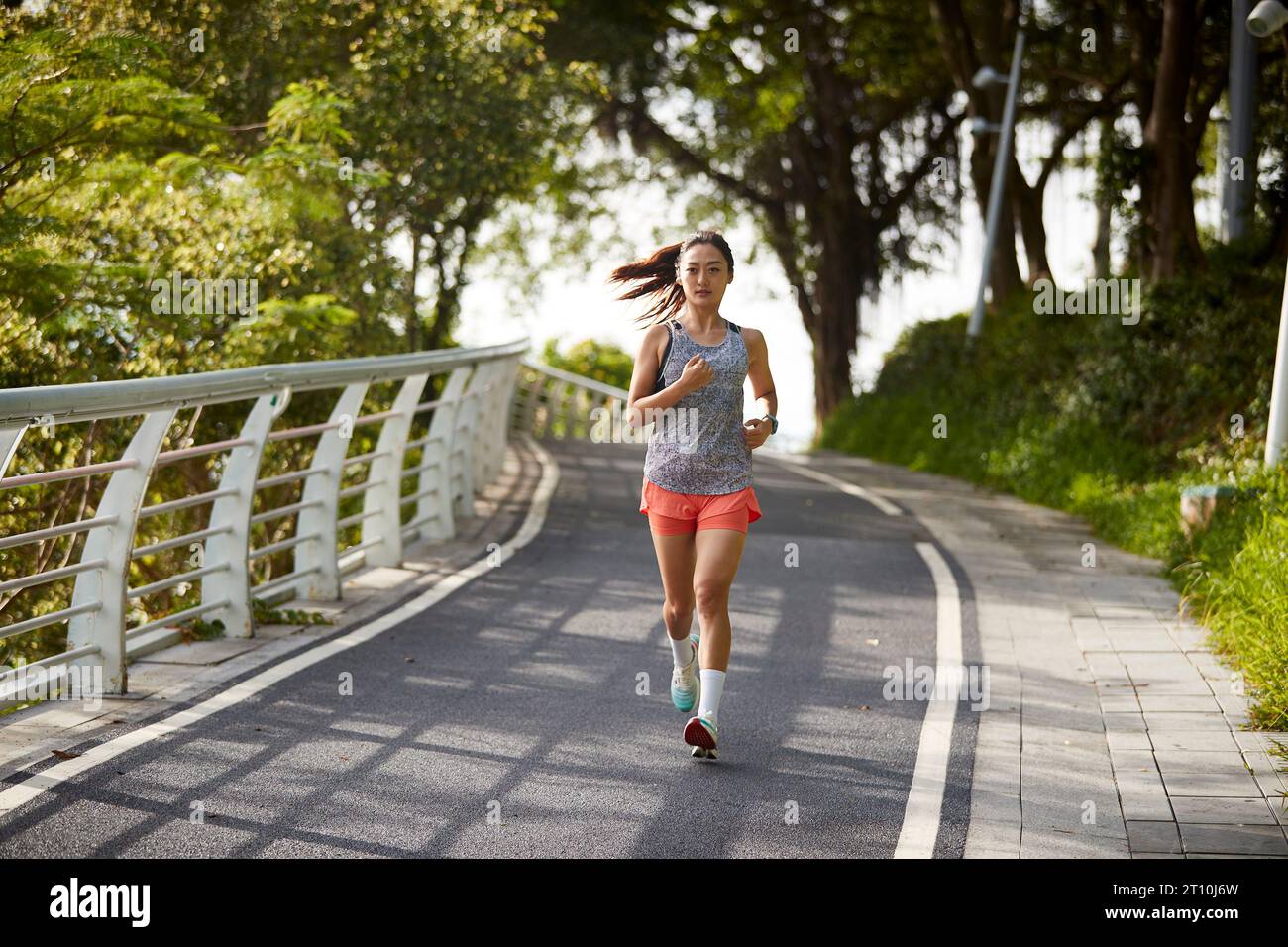 young asian woman female jogger exercising outdoors in city park Stock ...