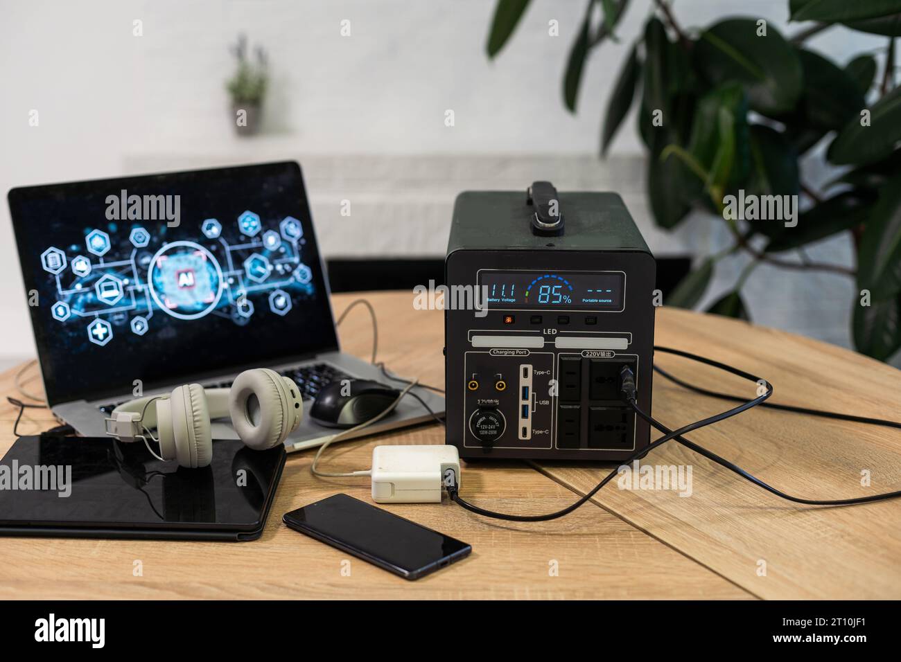 Portable power station charging gadgets near wall Stock Photo - Alamy