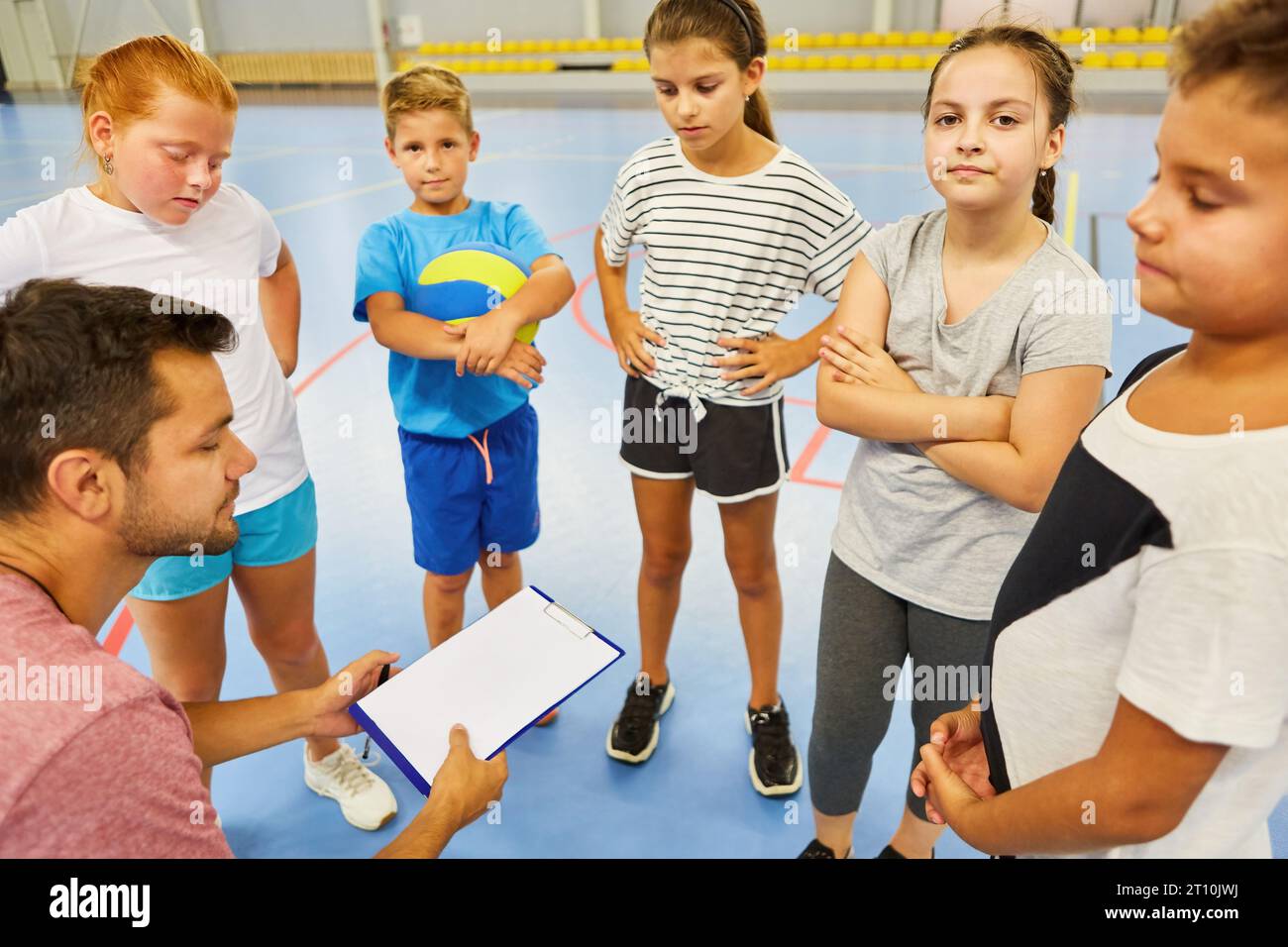 Elementary male and female students giving endurance test to teacher ...