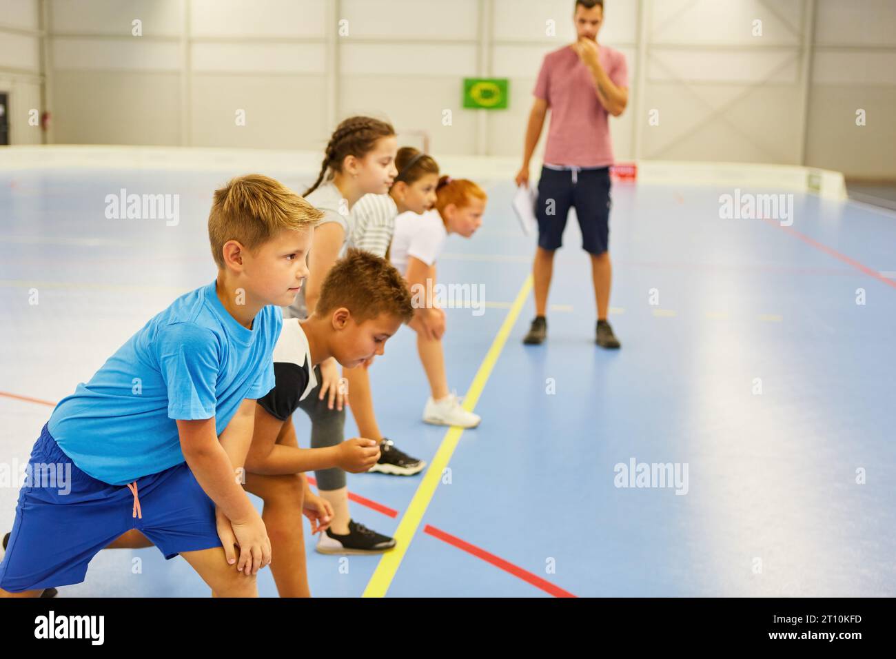 Group of elementary school students doing spring run in gym class Stock ...