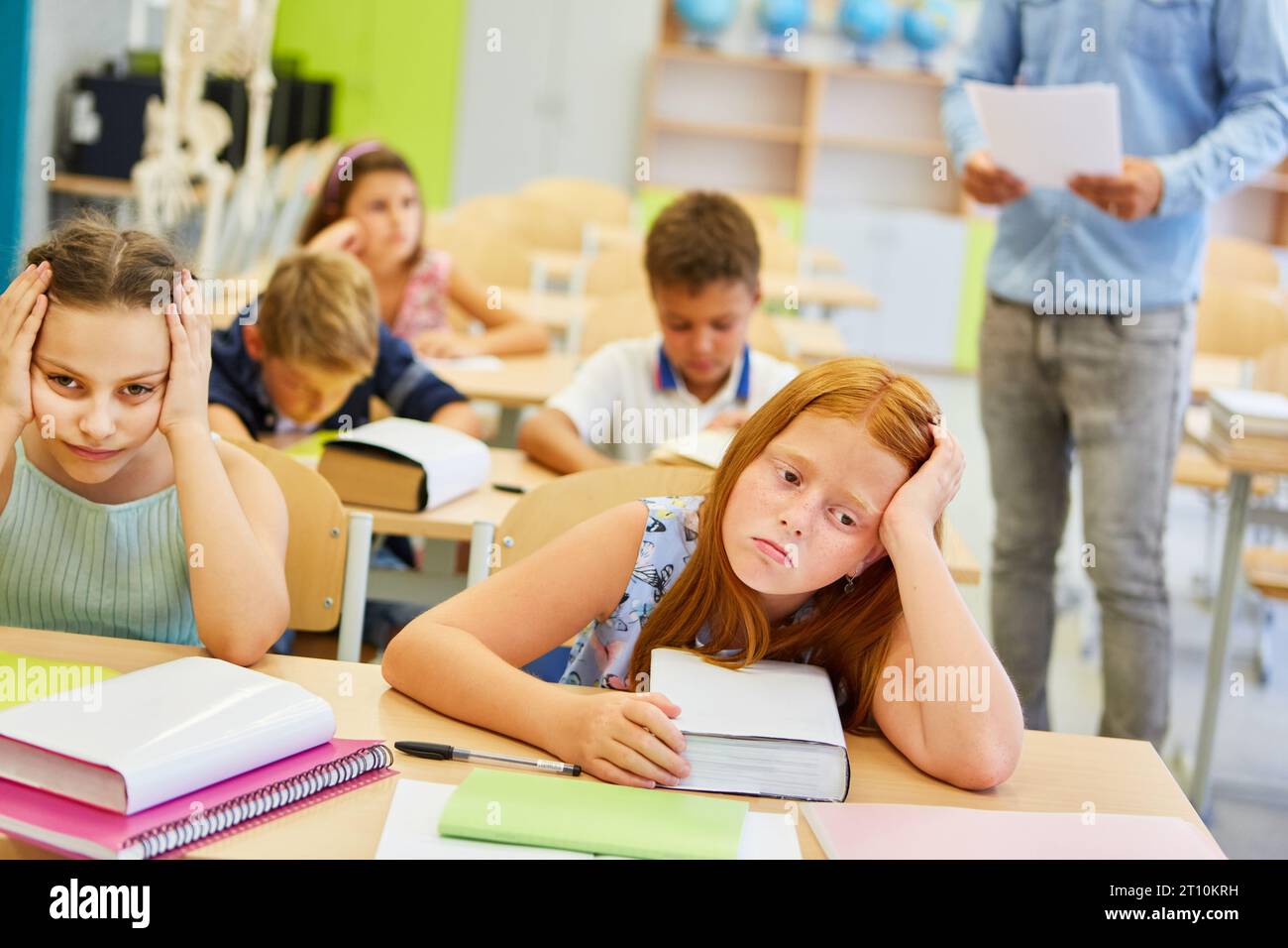 Upset female students sitting together on bench during lecture in ...
