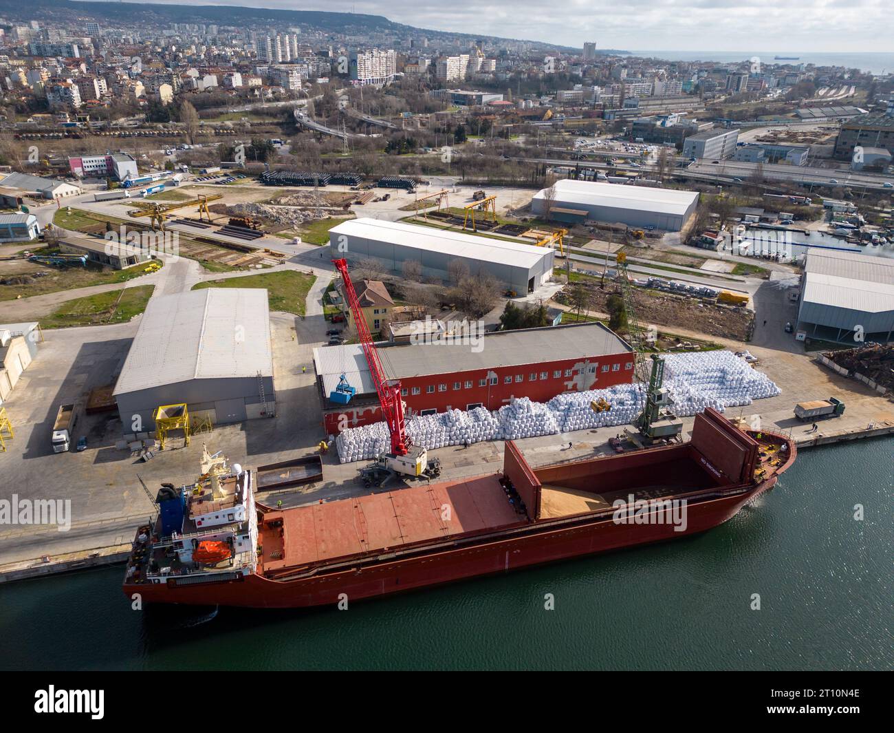 Aerial view of a bulk carrier ship loaded or downloaded with grain is ...