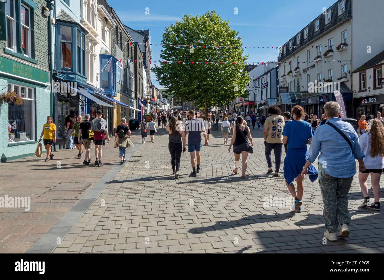 People tourists visitors walking in the town centre in summer Main ...
