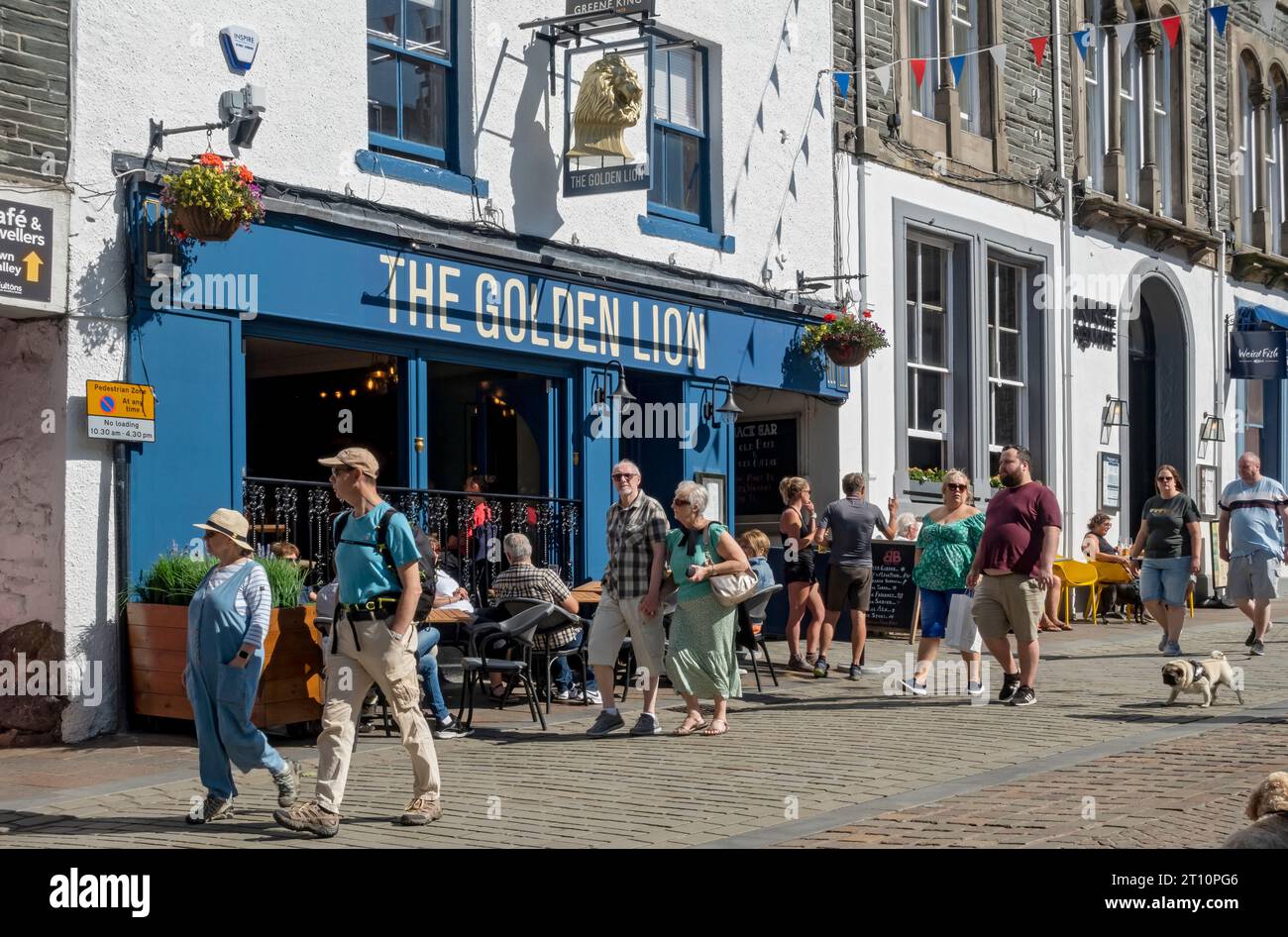 People drinking sitting relaxing outside seating at the Golden Lion Pub ...