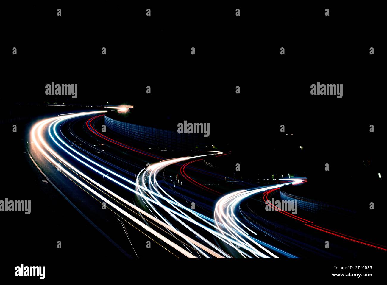 Speed motion at night, busy intersection light vehicle trails on the ...