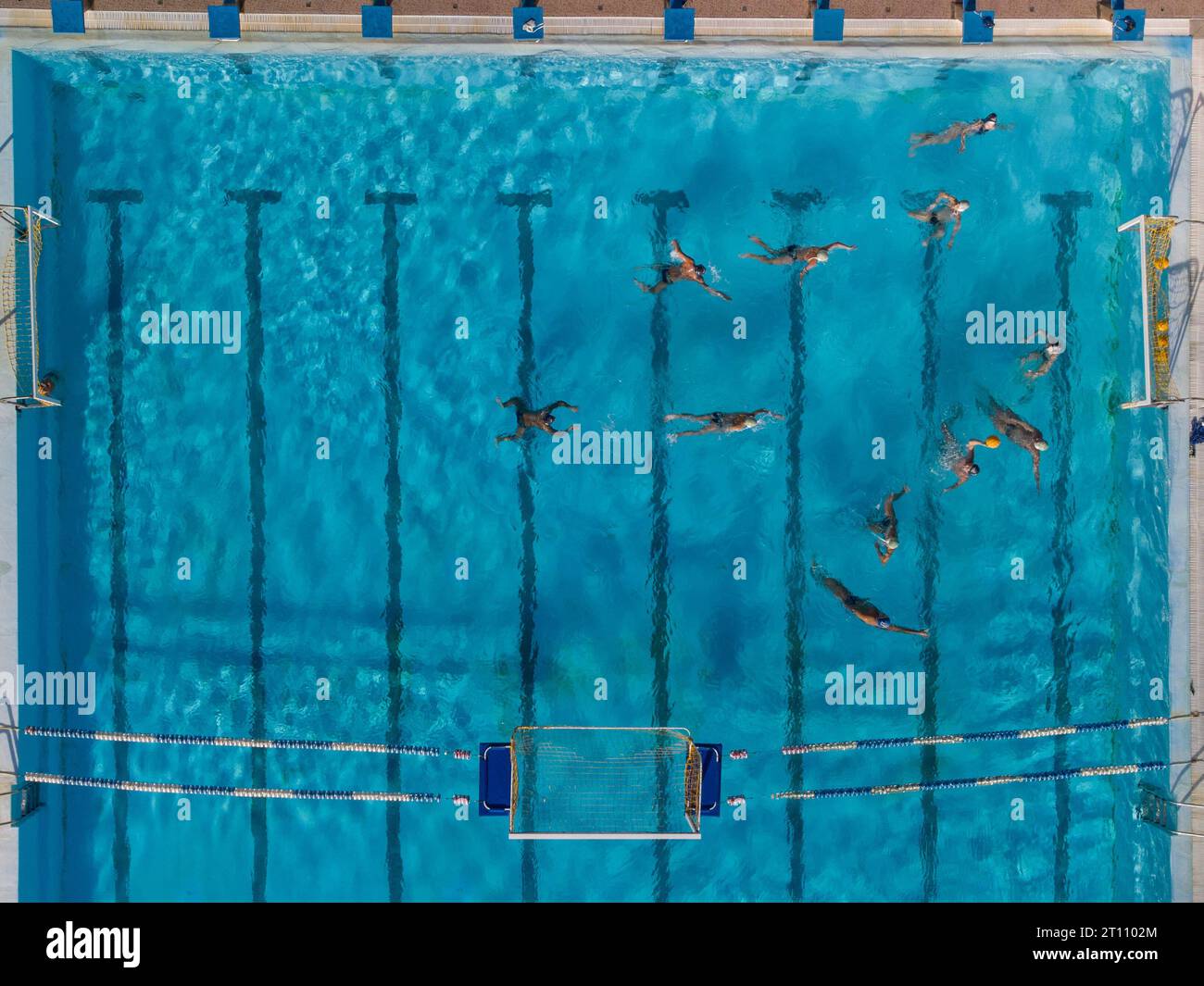 Aerial drone view shot of people competing in water polo in turquoise ...