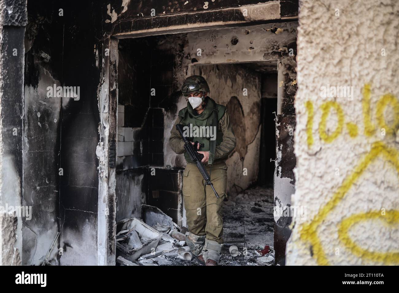 Kfar Aza, Israel. 10th Oct, 2023. An Israeli soldier inspects a ...