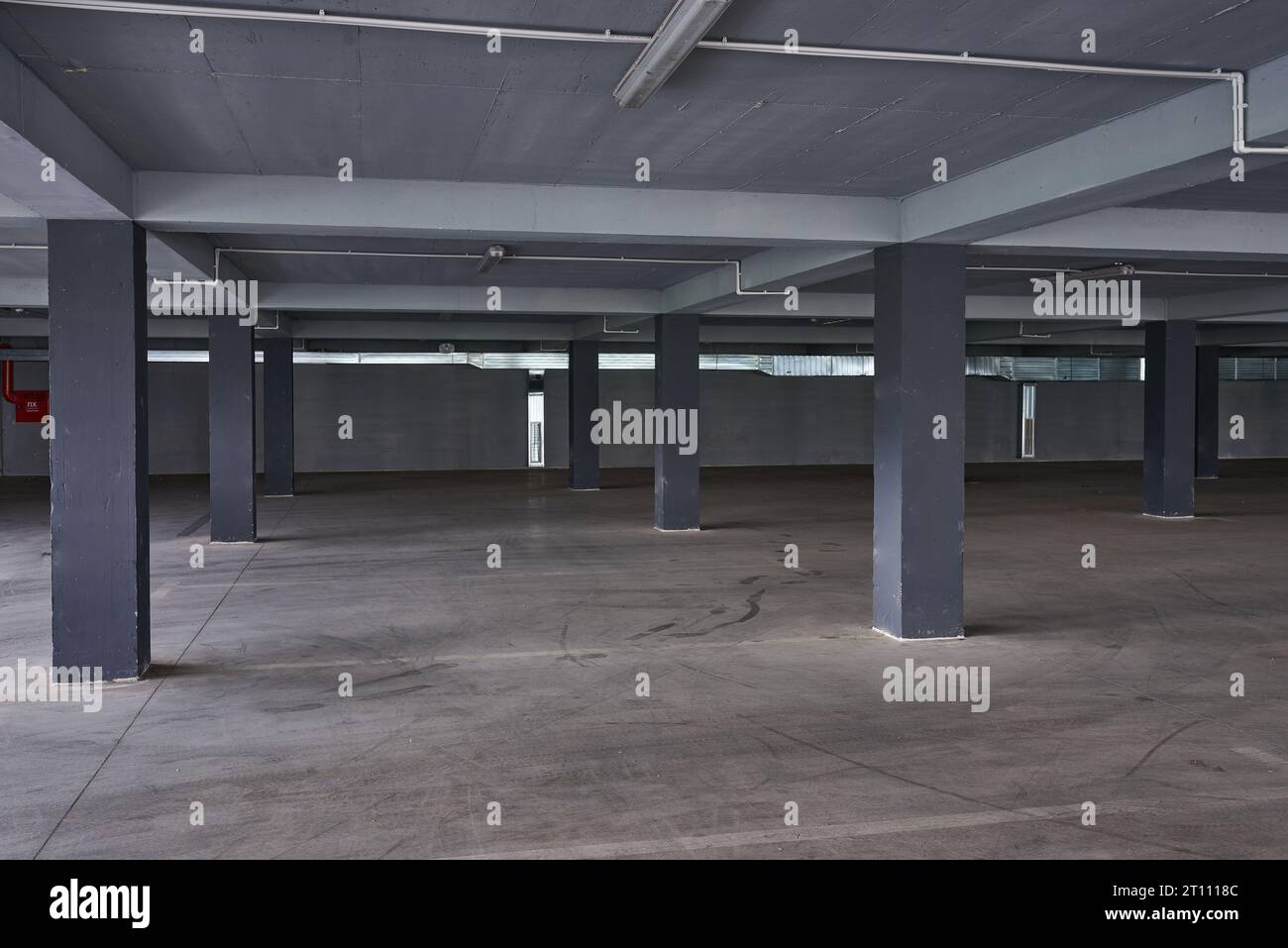 Empty underground parking lot garage interior with concrete columns ...