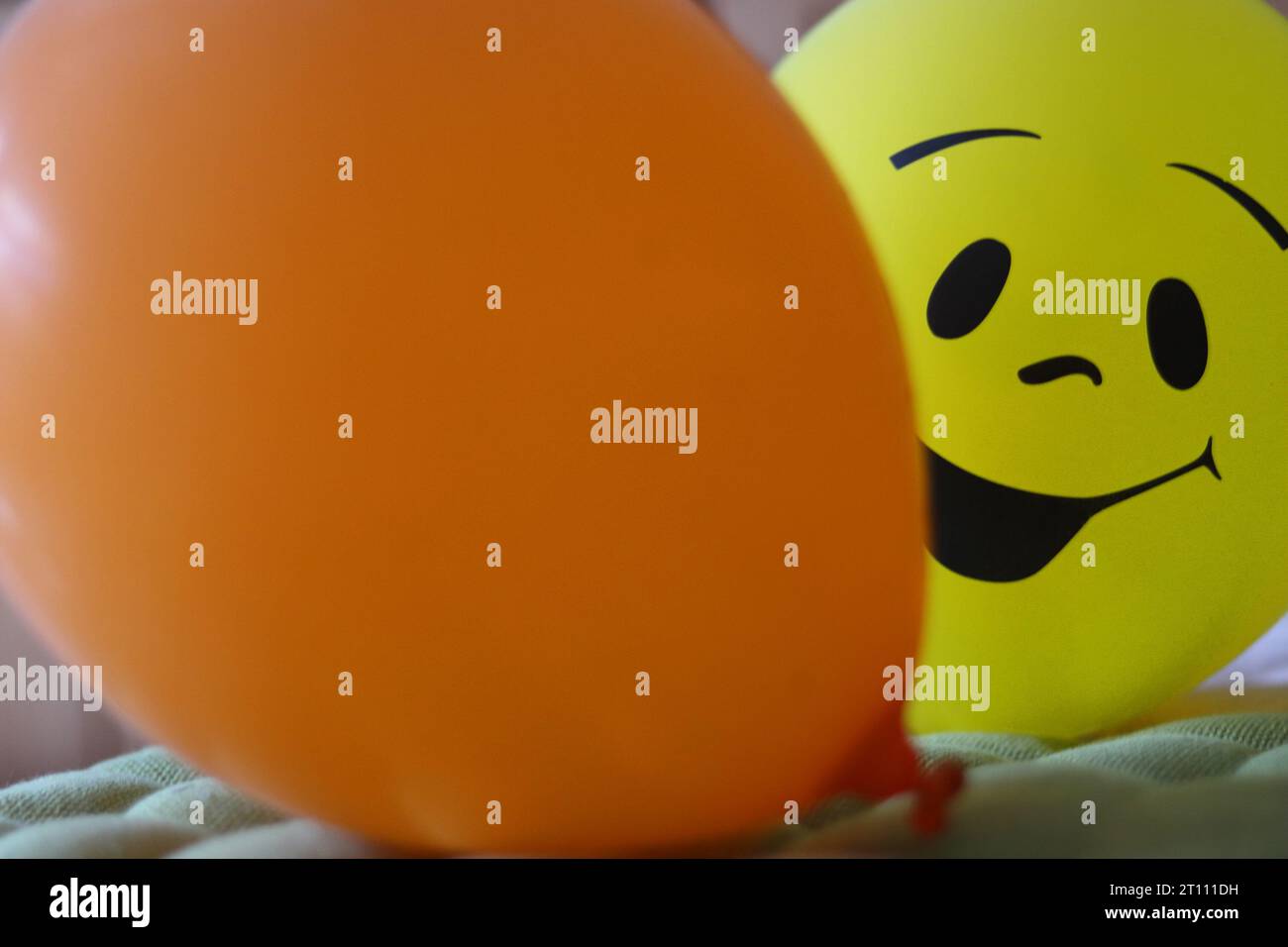 Yellow and orange balloons. Two hot air balloons laying on the carpet ...