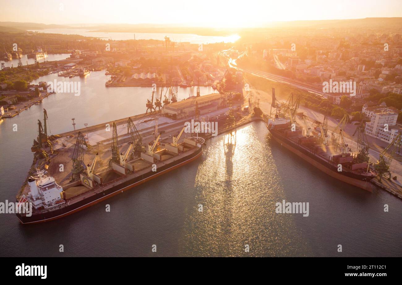 Aerial top view of big cargo ship bulk carrier is loaded with grain of ...