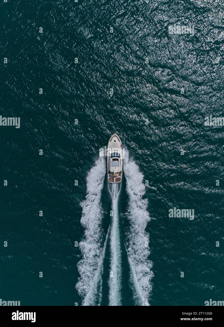 Aerial top down view of white speed motor boat on open sea at summer ...