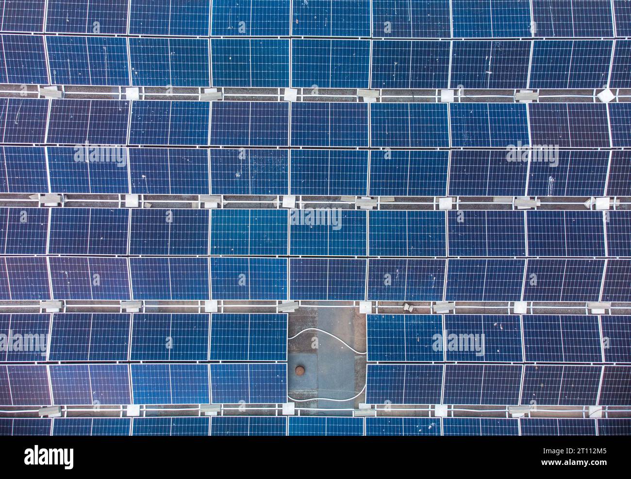 Solar panels installed on a roof of a large building. Aerial top view ...