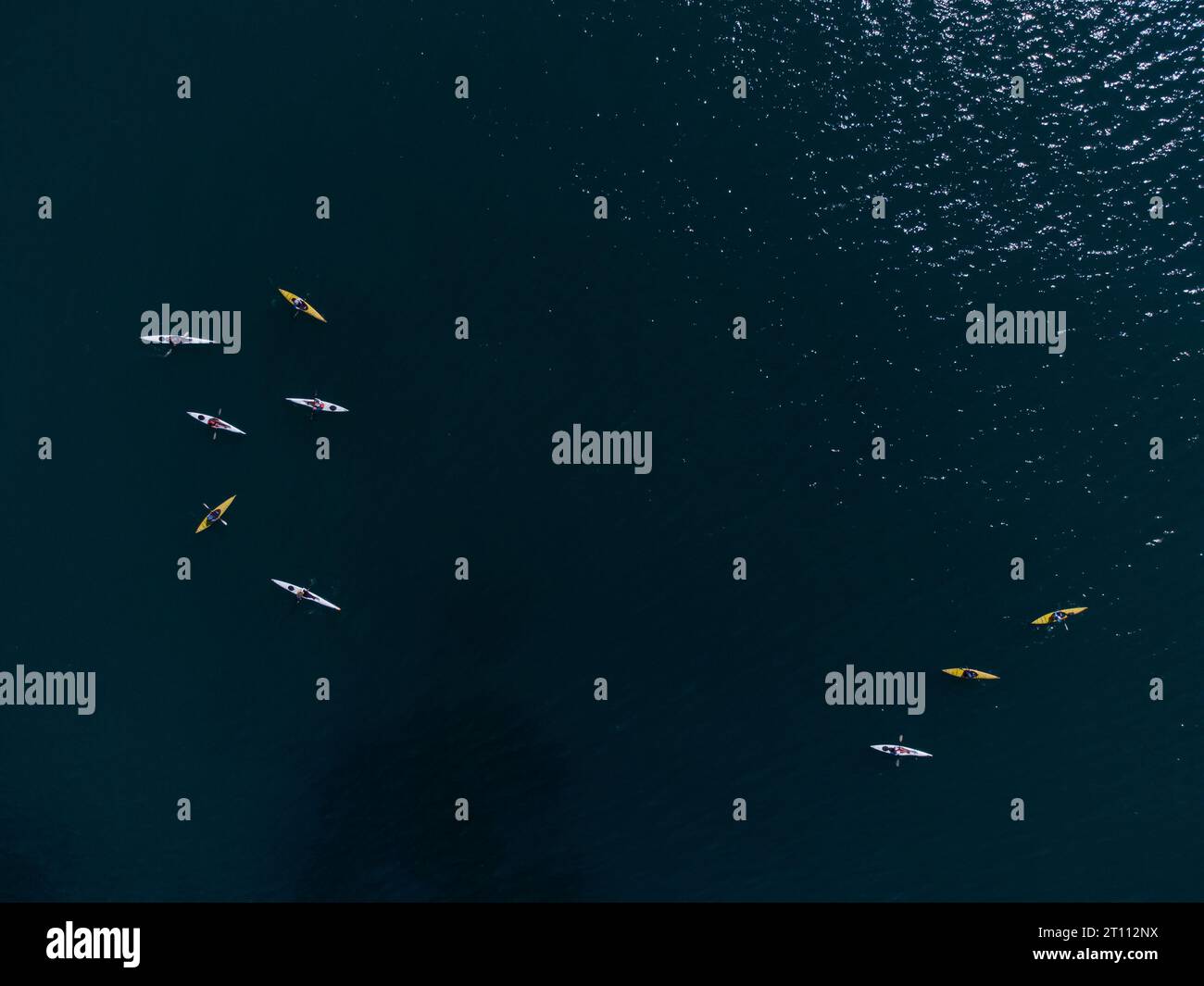Aerial top view of a small group of people sea kayaking Stock Photo - Alamy