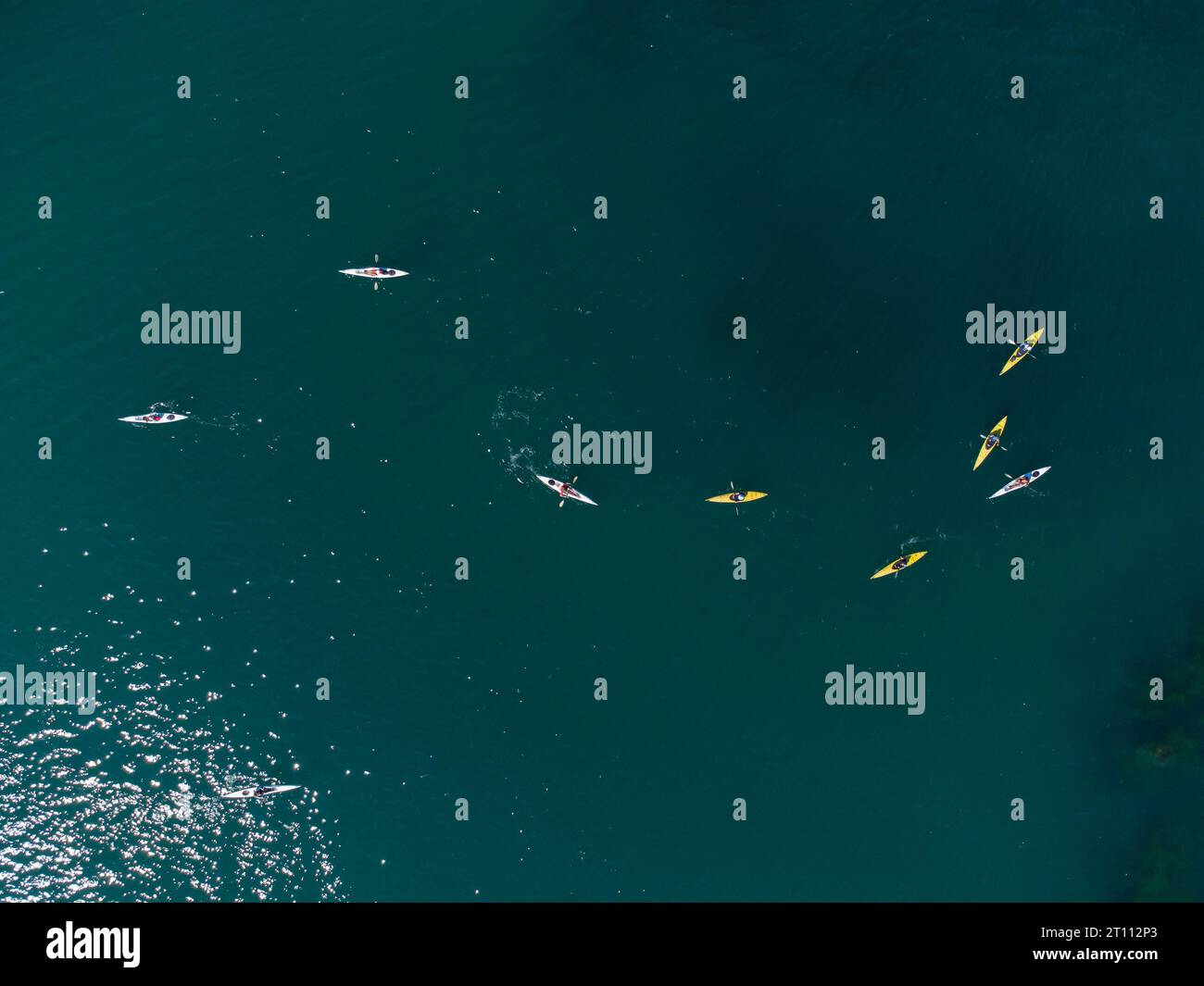 Aerial top view of a small group of people sea kayaking Stock Photo - Alamy
