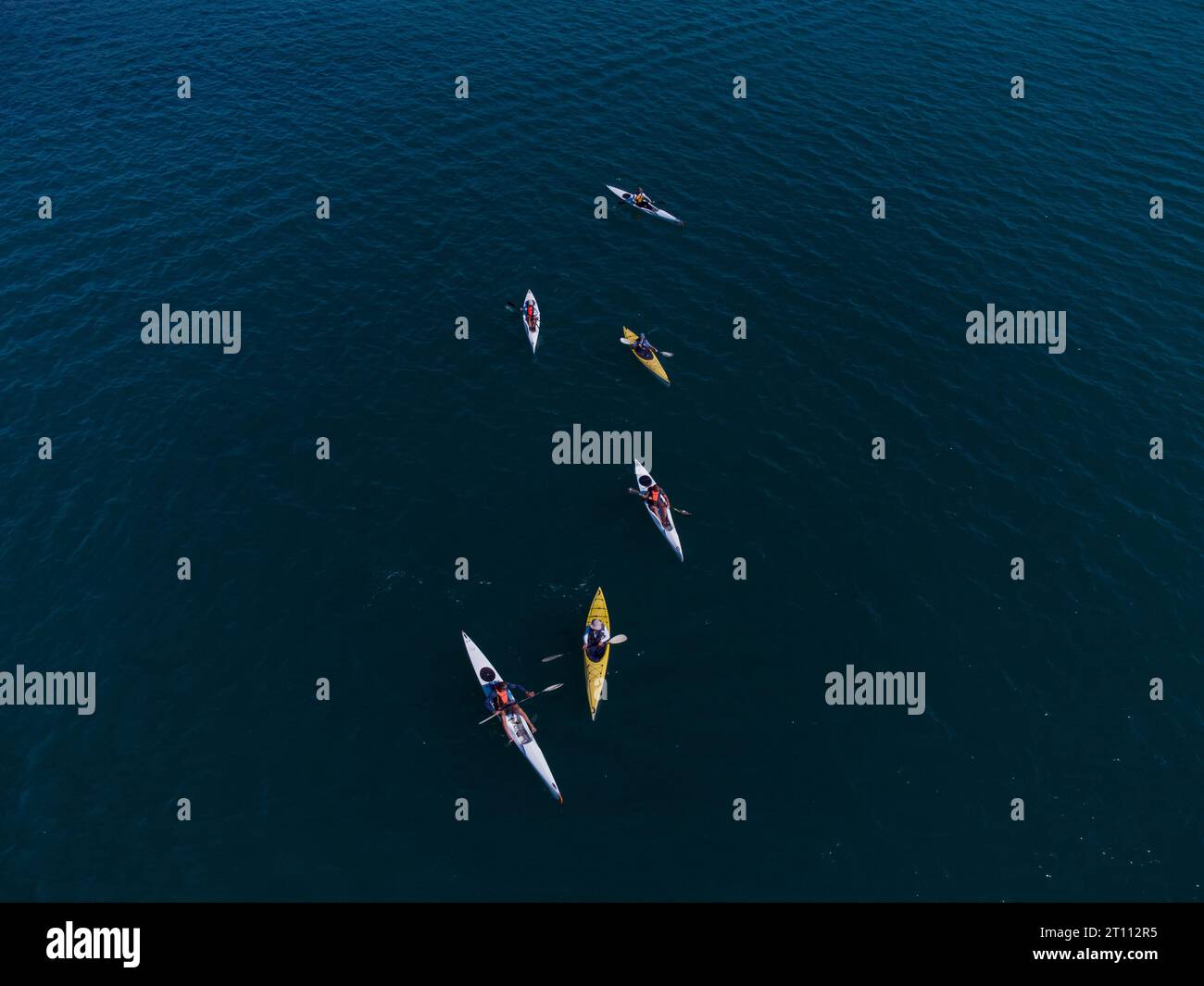 Aerial top view of a small group of people sea kayaking Stock Photo - Alamy