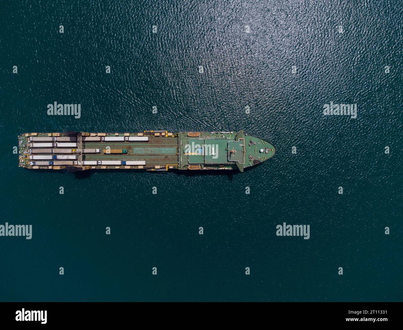 Aerial top view of a ferry boat transporting trucks in the sea Stock ...