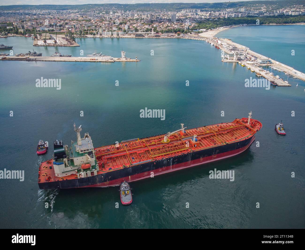Aerial top view of tanker ship with escorting tug leaving port Stock ...