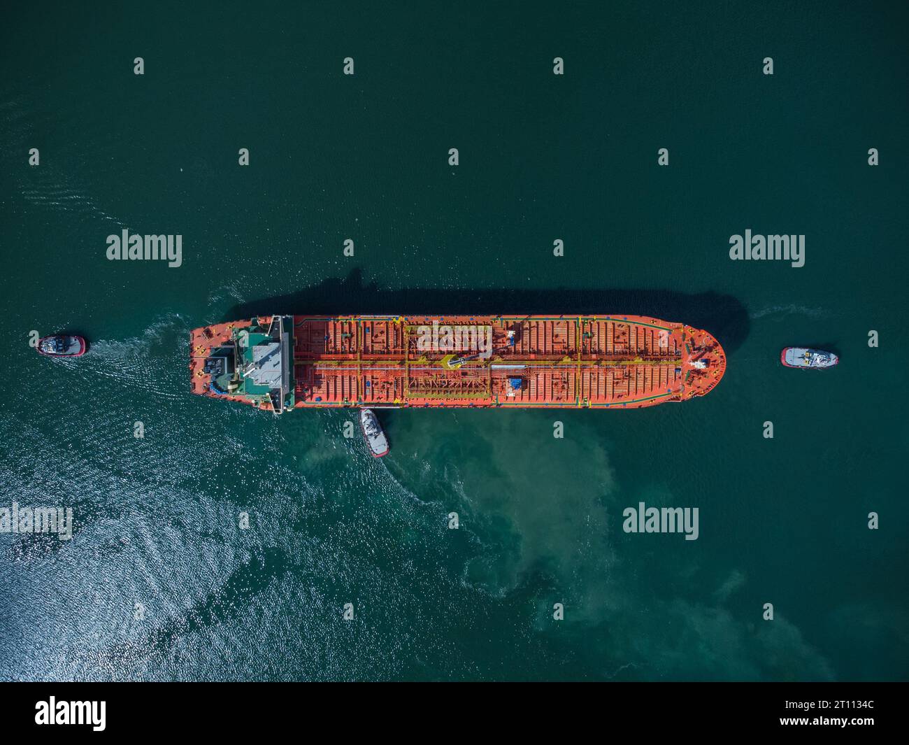 Aerial top view of tanker ship with escorting tug leaving port Stock ...