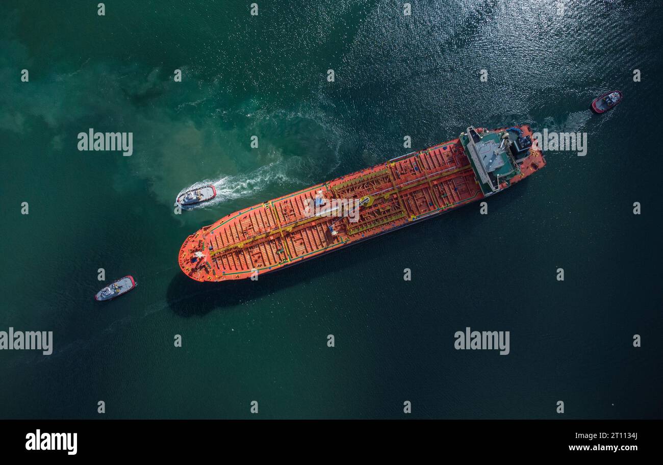 Aerial top view of tanker ship with escorting tug leaving port Stock ...