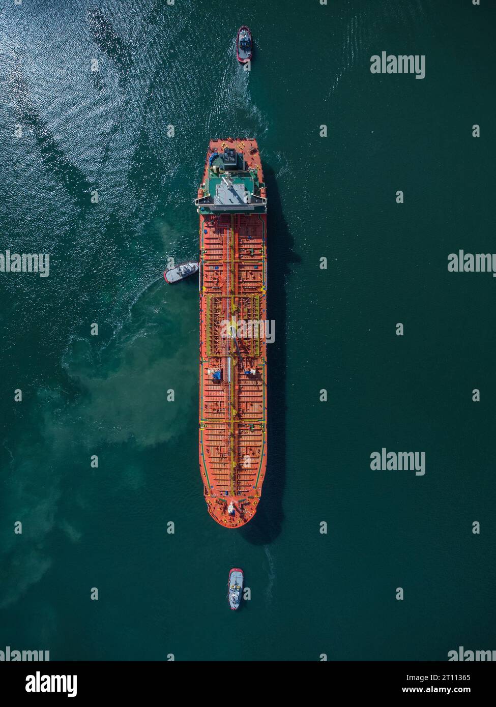 Aerial top view of tanker ship with escorting tug leaving port Stock ...