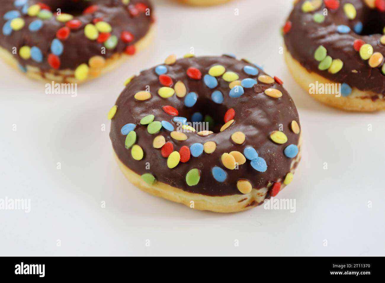 Set of Brown chocolate donut decorated with smarties isolated on white ...