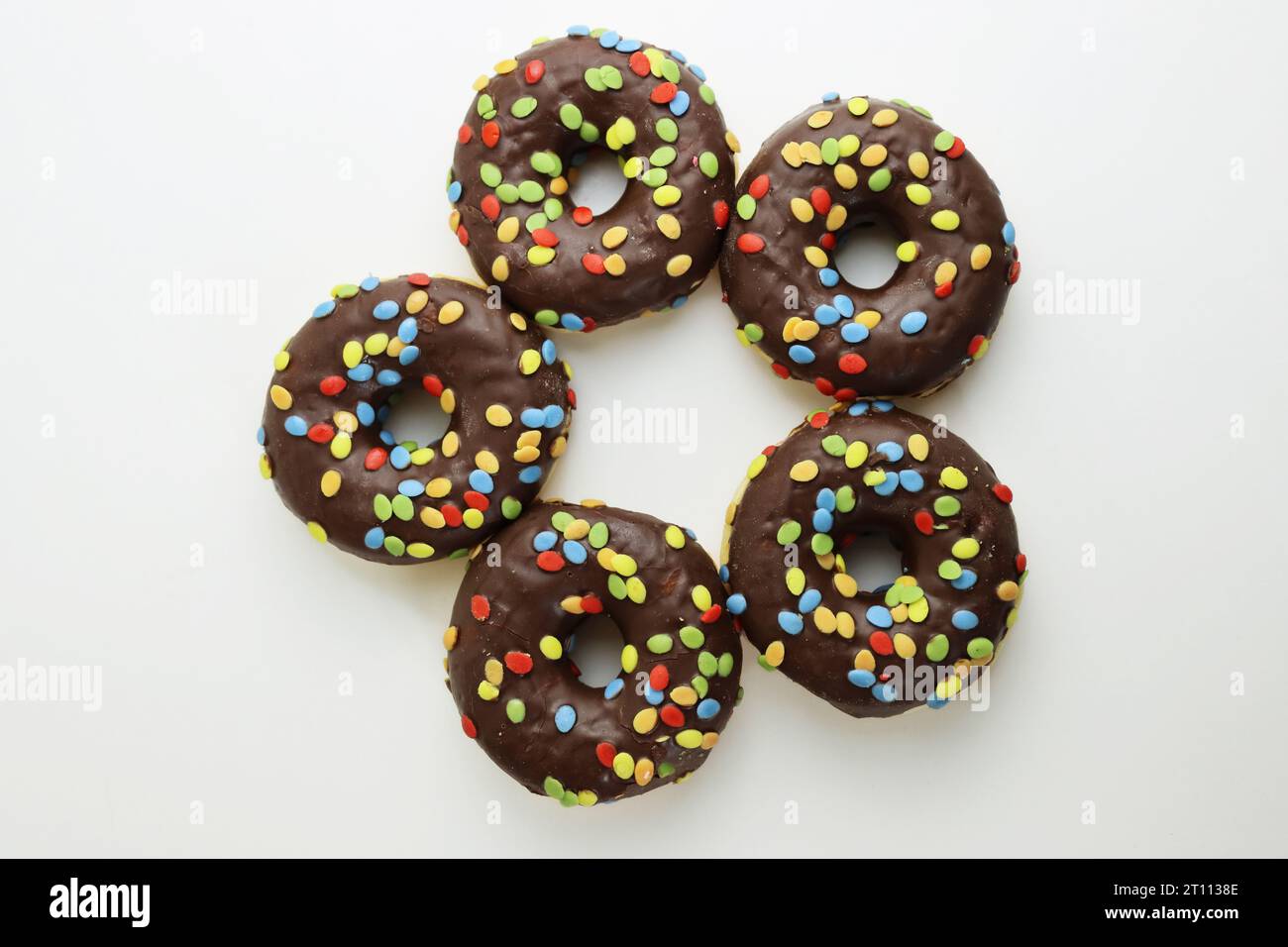 A set of doughnuts glazed with chocolate and colorful smarties. Five ...