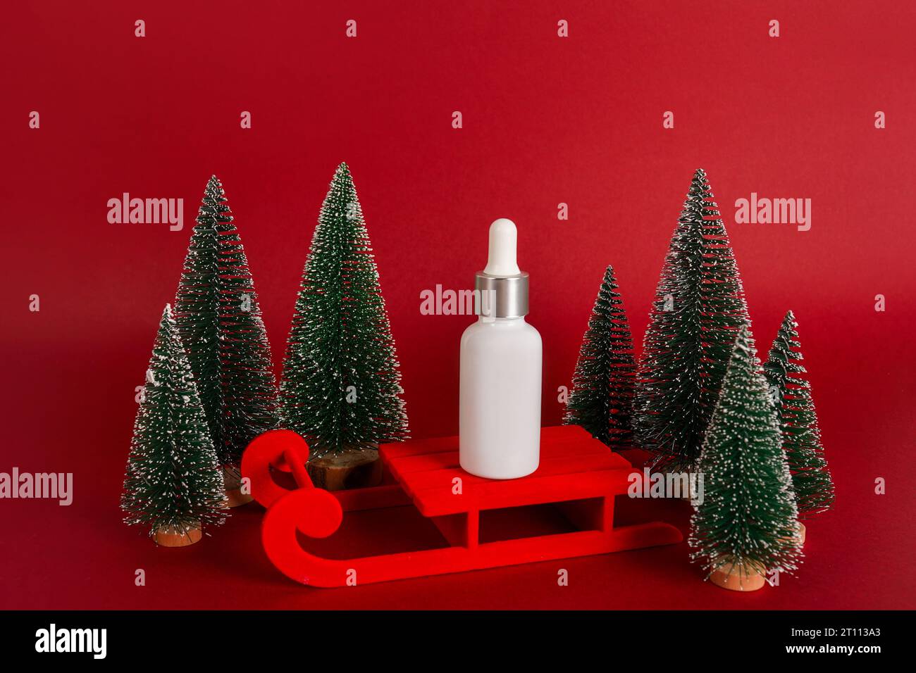 Cosmetic product oil or face serum in white glass bottle standing on ...