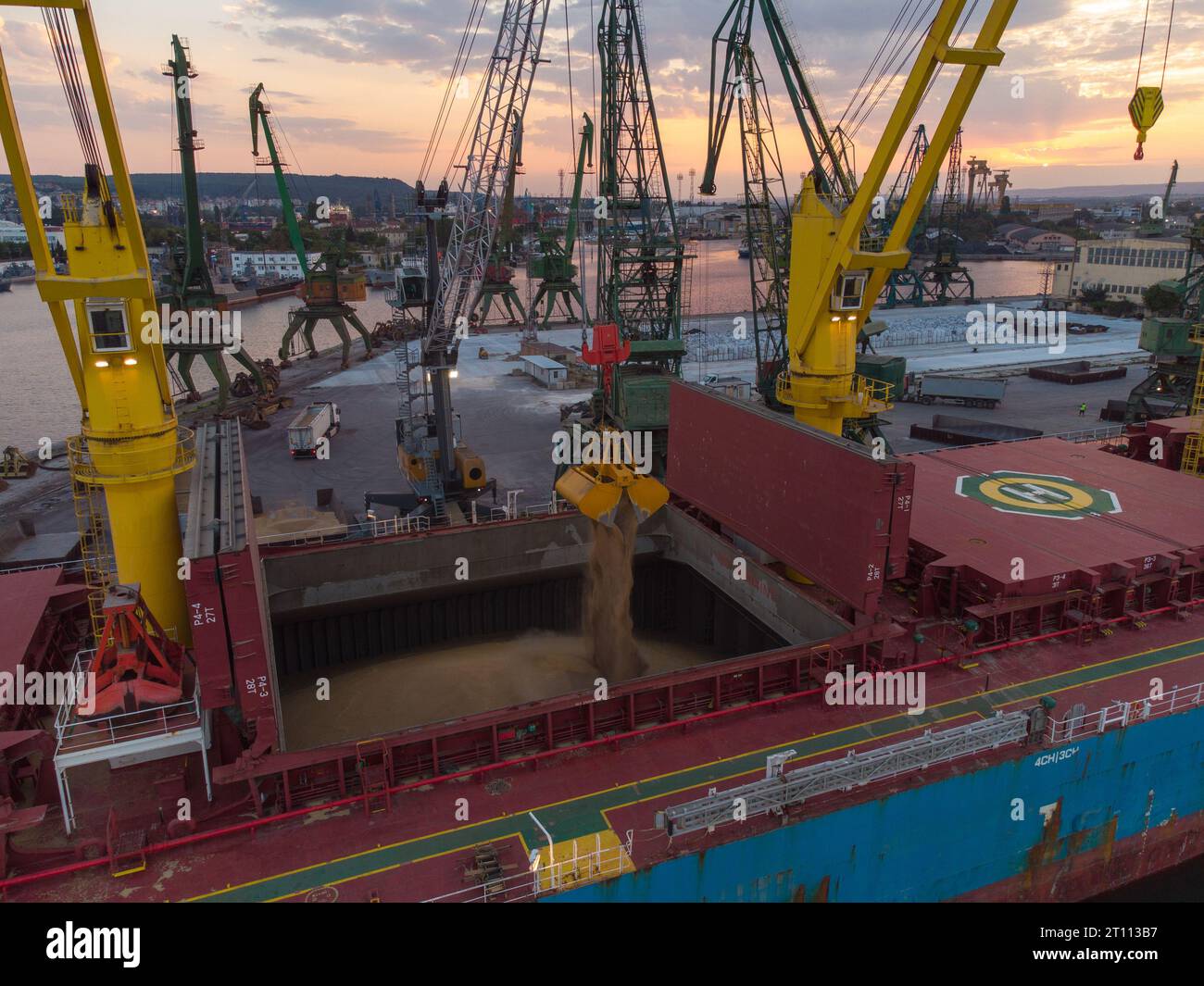 Aerial view of big cargo ship bulk carrier is loaded with grain of ...