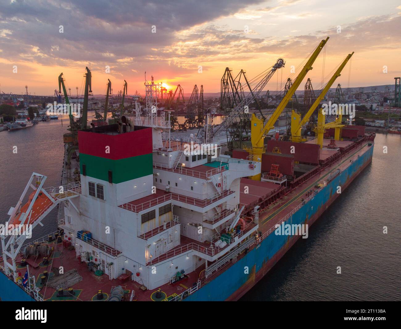 Aerial view of big cargo ship bulk carrier is loaded with grain of ...