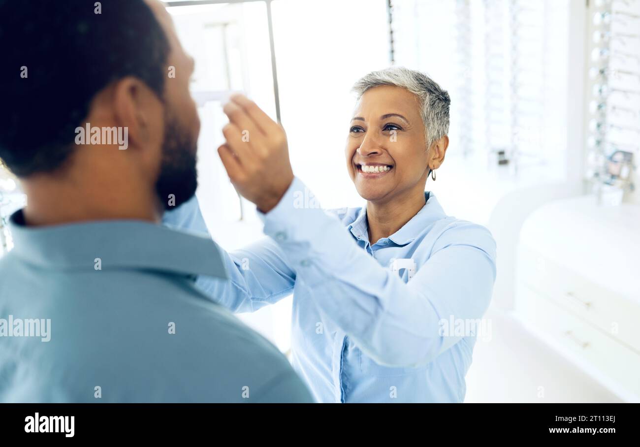Woman optometrist, fitting and customer in store with consultation for ...