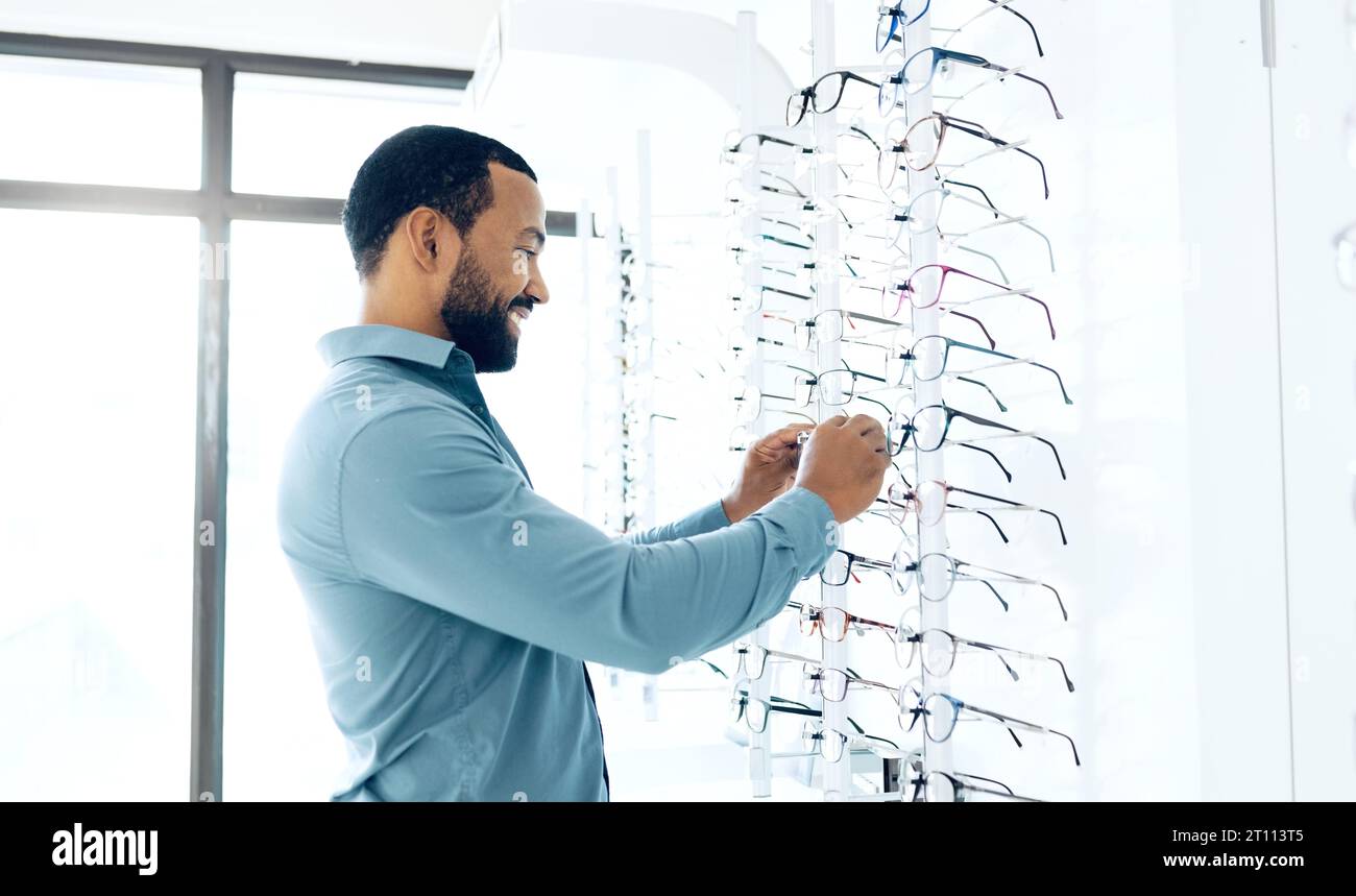 Optometry store glasses and man for decision, choice and eye care ...