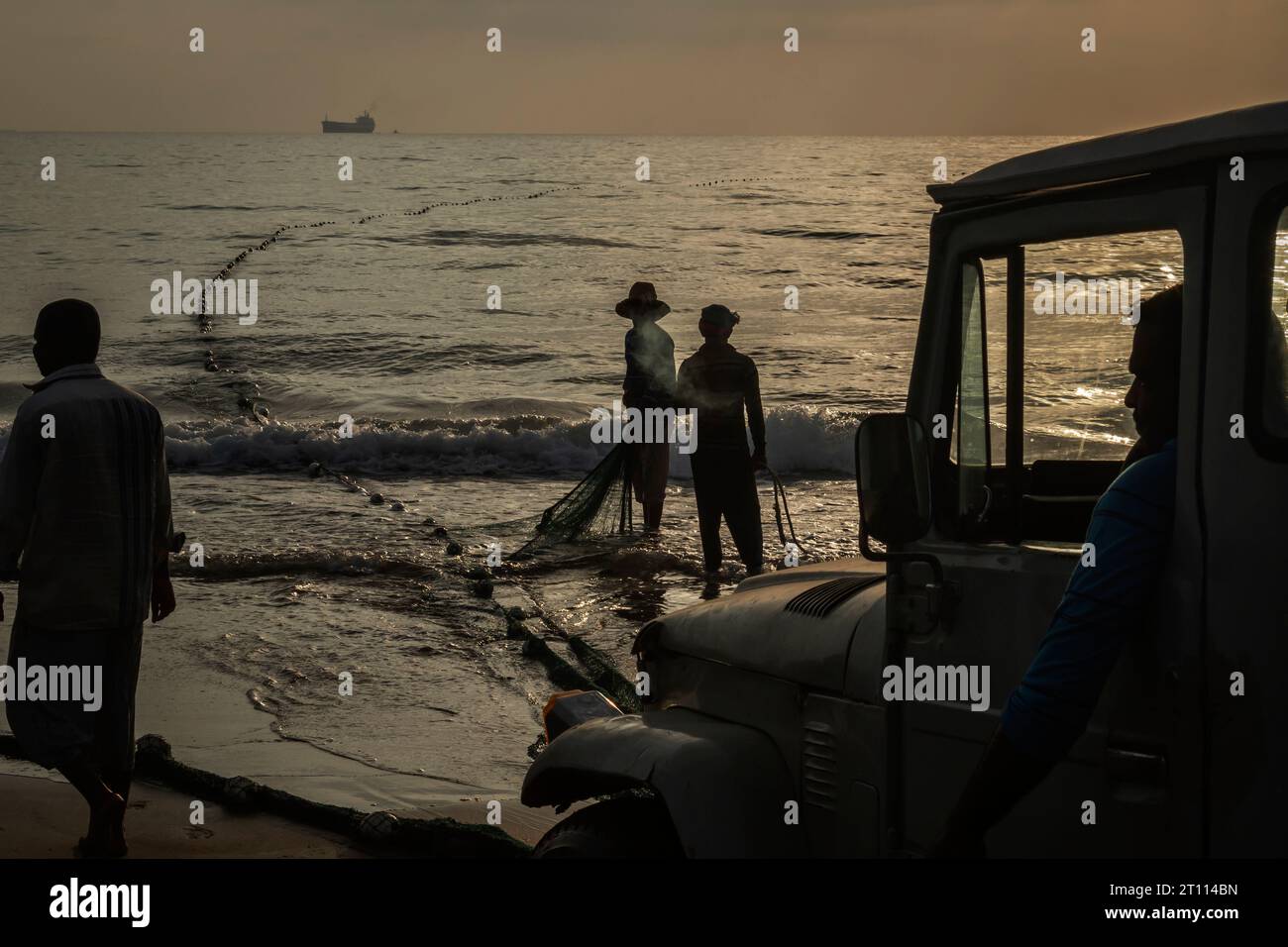 Early morning fisherman on duty at Fujairah beach, United Arab Emirates ...