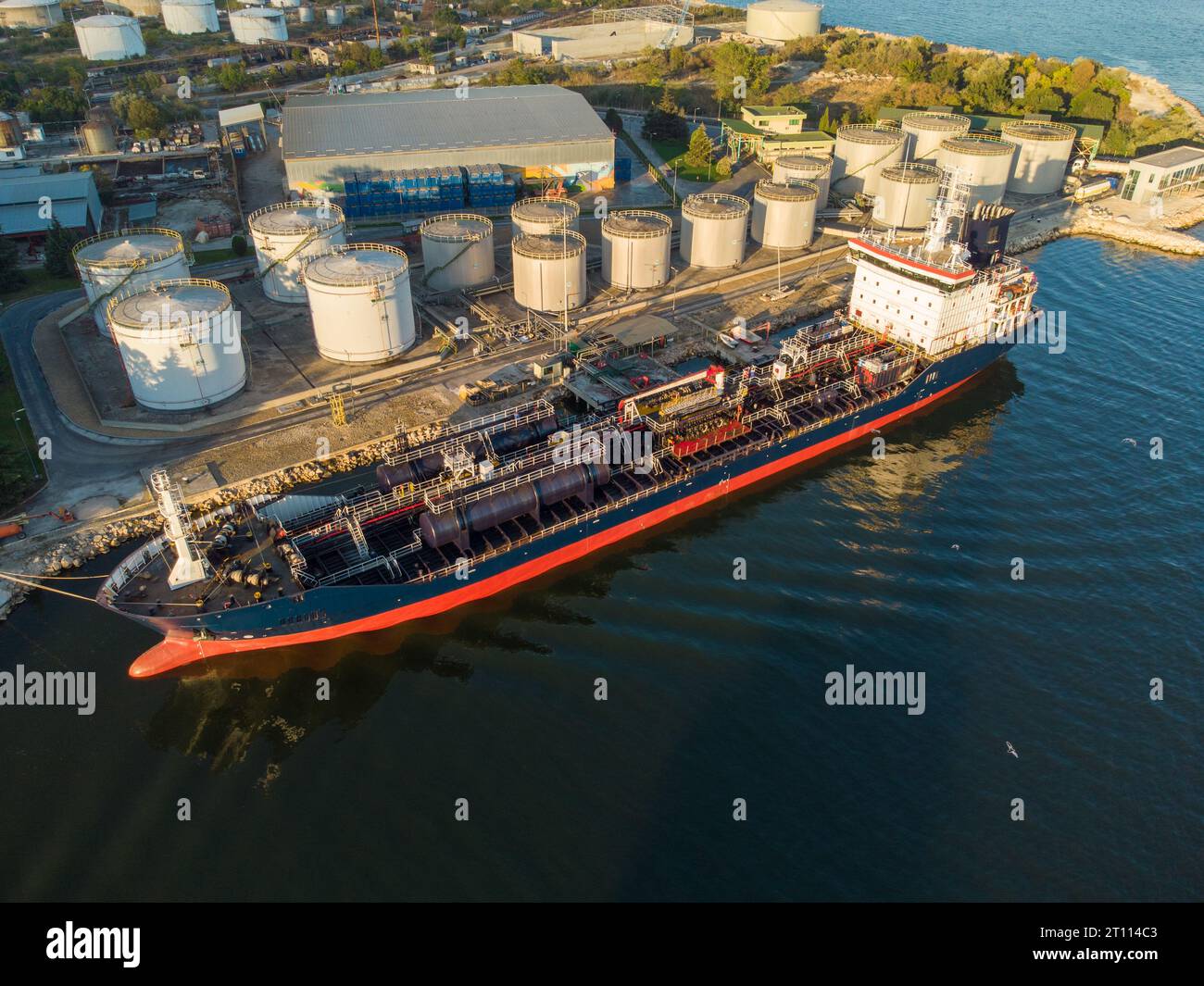Aerial view of Chemical industry storage tank and tanker ship entering ...