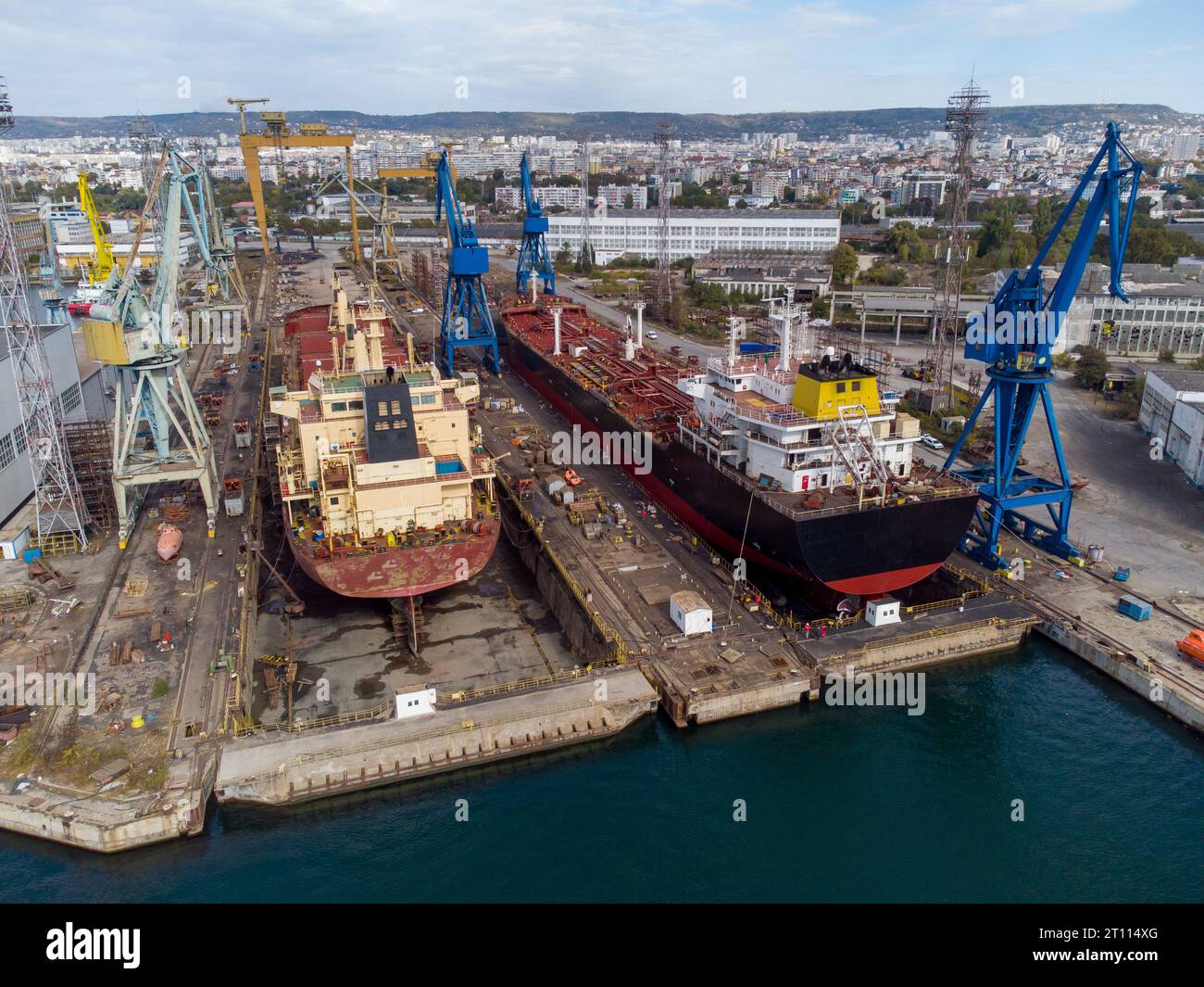 aerial top view shipyard dry dock maintenance and repair cargo ship ...