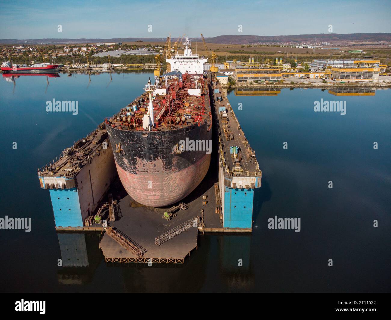 aerial top view shipyard dry dock maintenance and repair cargo ship ...
