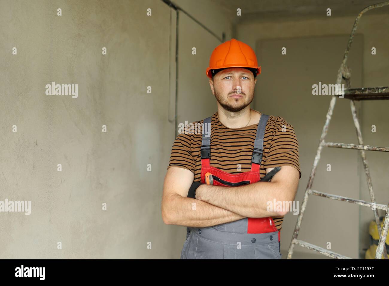 Renovation apartment. Portrait of young confident male foreman ...