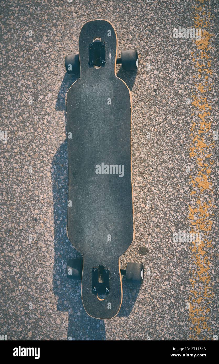 double kick cutaway longboard on asphalt without people, evening photo ...