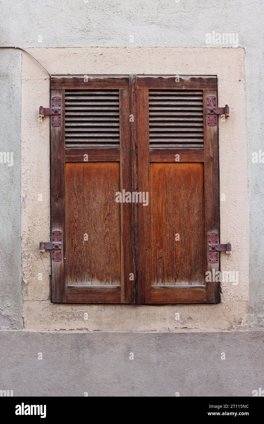 Country style window with closed ancient retro wooden shutters. Antique ...