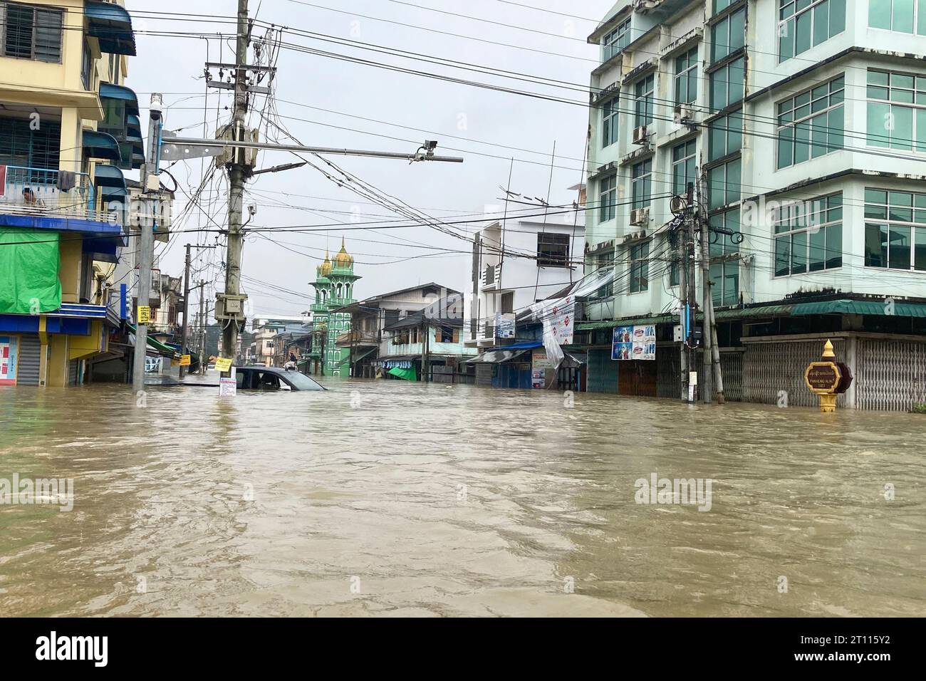 A sinked car is seen on a flooded road in Bago, about 80 kilometers (50 ...